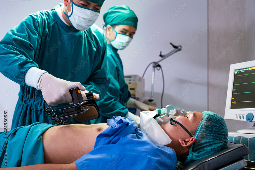 Selective focus at defibrillator while doctor use it to pump at chest ...