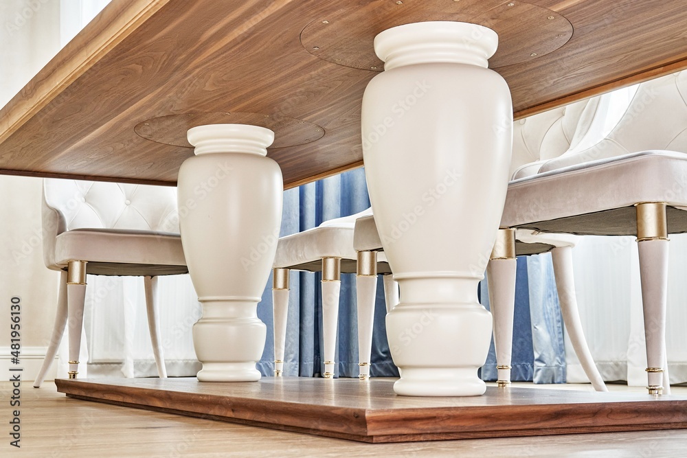 Massive turned white legs of luxury vintage dining table with top of ...