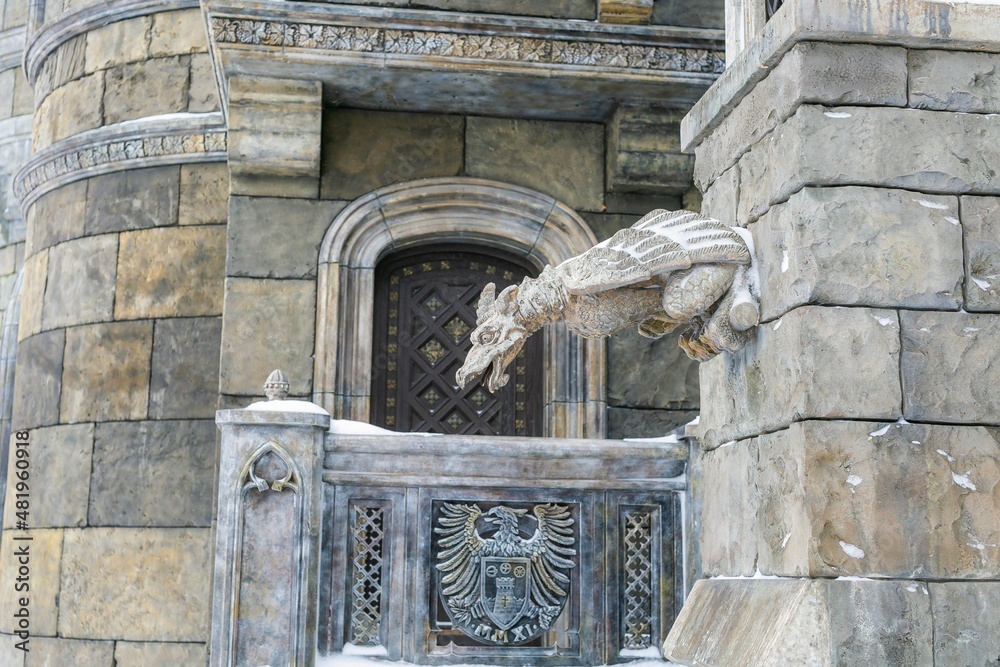 Gargoyle statue attached to the wall of the castle Stock Photo | Adobe ...