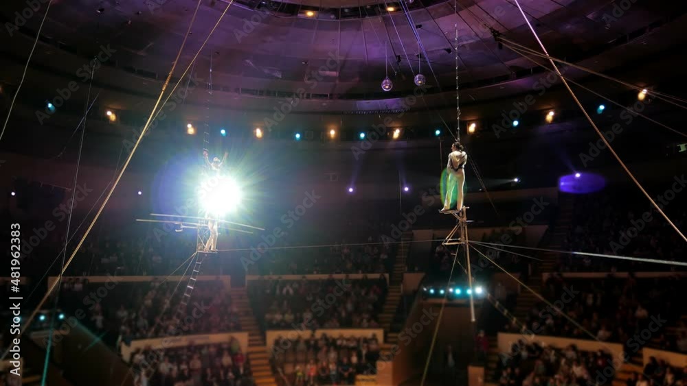 Wideo Stock: Performance of three aerial tightrope walkers gymnasts in ...