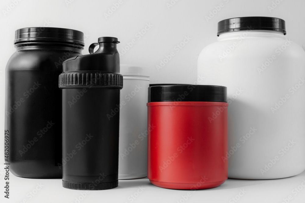 containers of weight gainers, protein and creatine on a white isolated ...