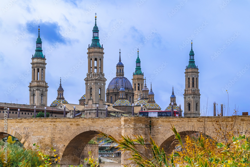 Medieval stone bridge Puente de Piedra with arches on the background of ...