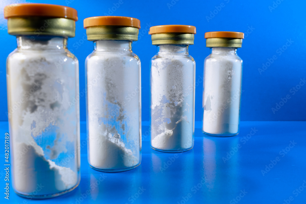 Vials of medicines with red caps. Closed medicine bottles. Vials with ...