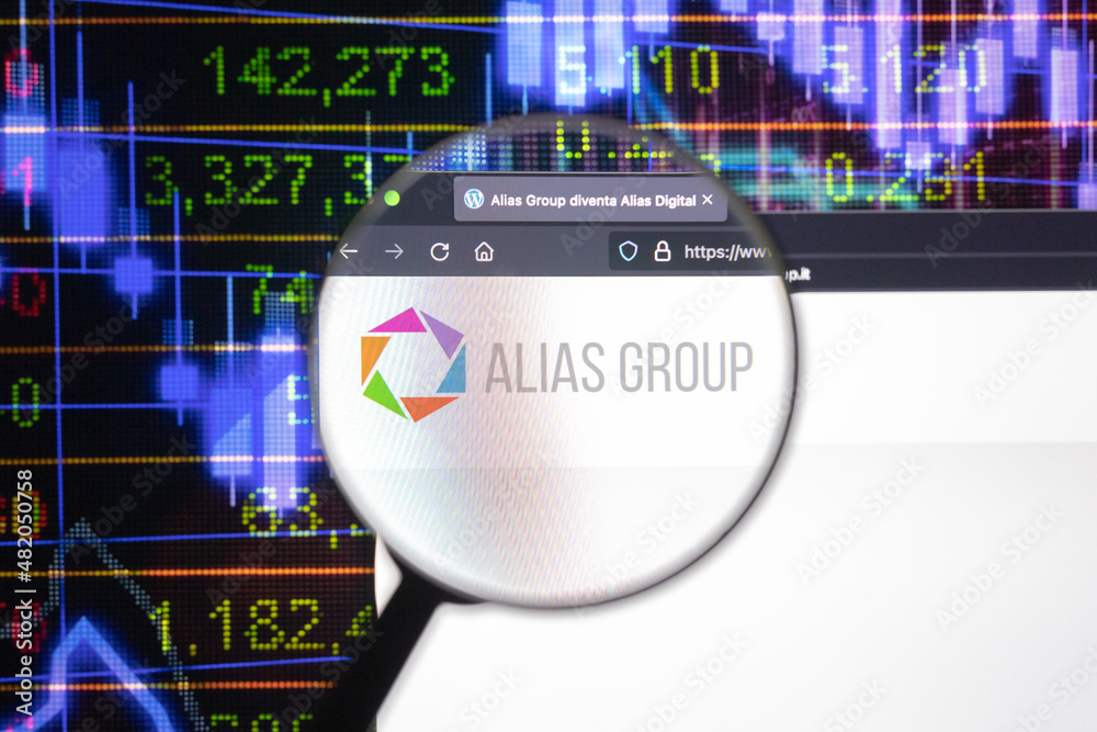 Alias Group company logo on a website with blurry stock market ...