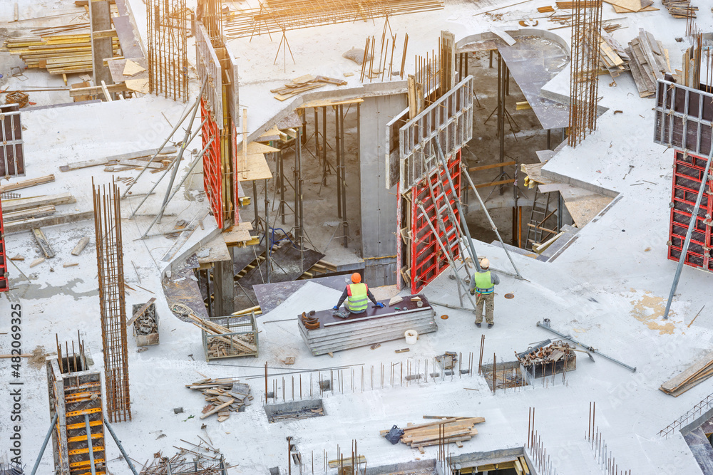 Building construction site work against blue sky.Hydraulic luffing jib ...