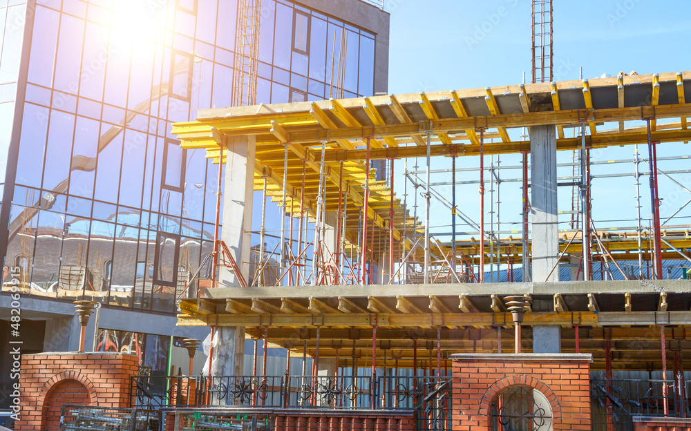 Building construction site work against blue sky.Hydraulic luffing jib ...