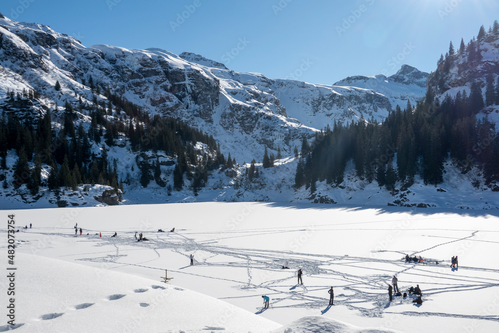 Eisfischer auf dem gefrohrenen Stausee Garichti Stock Photo | Adobe Stock