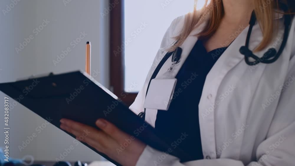 Medical personal stuff in white uniform is making notes on the tablet ...