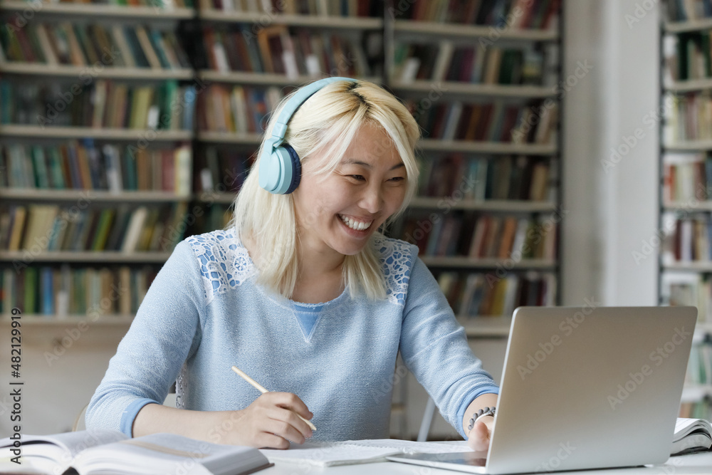 Happy excited gen Z hipster college student girl in headphones enjoying ...