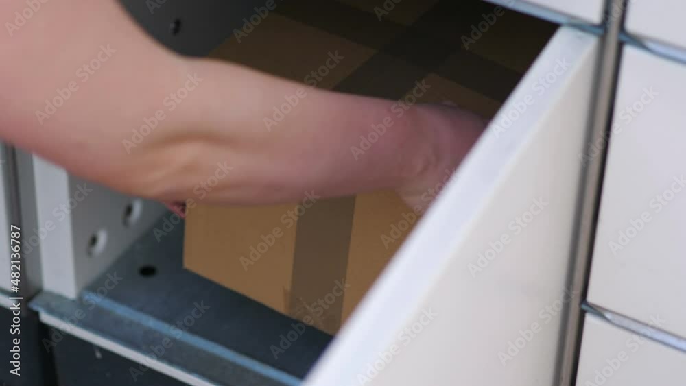 Putting a parcel to a parcel locker in 4k slow motion 60fps Stock ビデオ ...