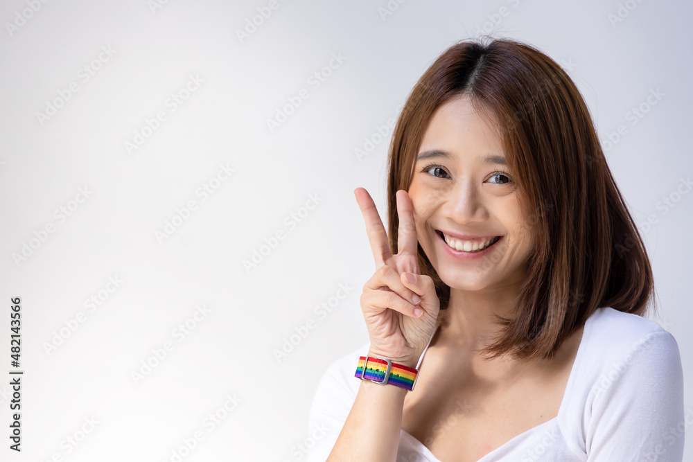 Happy Lgbt Woman Wearing Lgbtq Rainbow Wristband Showing V Sign For
