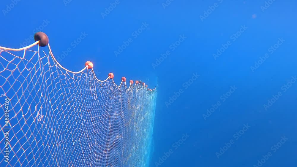 4K.Fishing net hanging from the boat under the sea.Underwater fishing ...