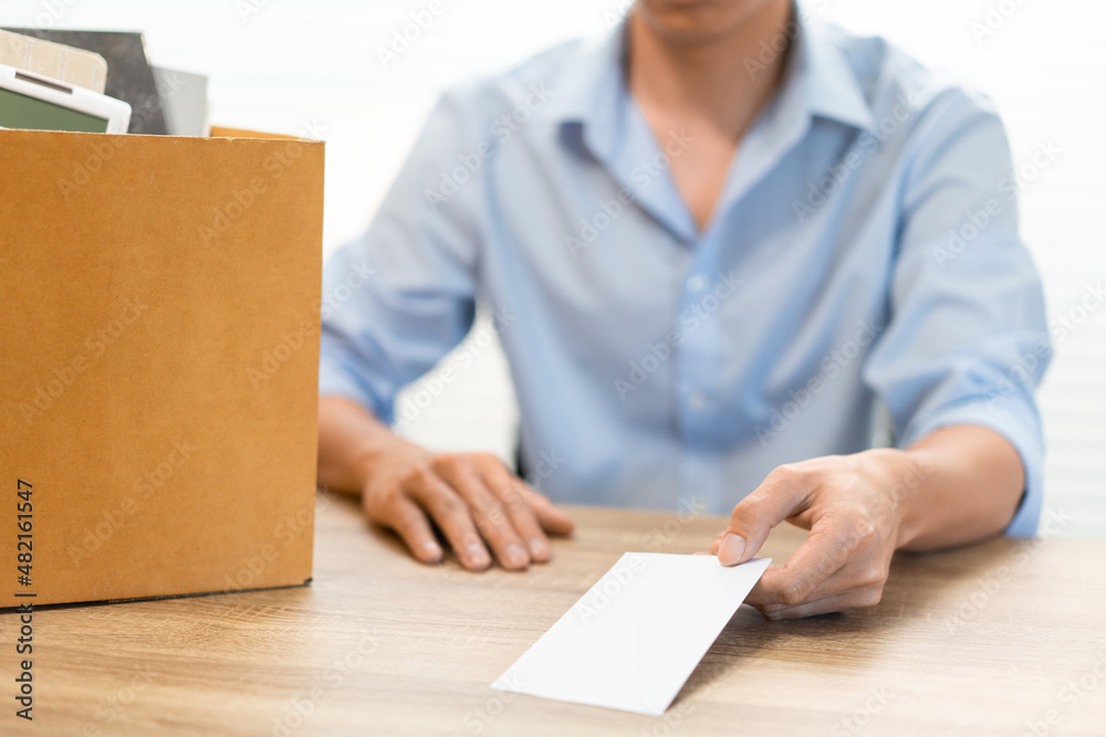 Resignation Concept The male officer sitting, putting his box of his ...