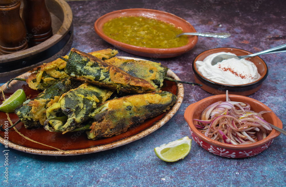 Vegetarian chiles rellenos served with green chile salsa, sour cream ...
