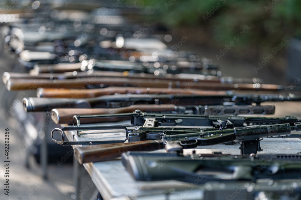 collection of historical and modern weapons on the shooting range Stock ...