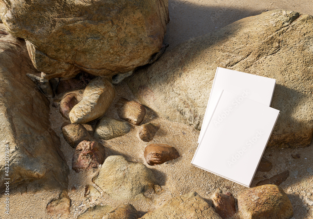 Blank book model placed on rocks in the sand, notebook mockup, mockup ...