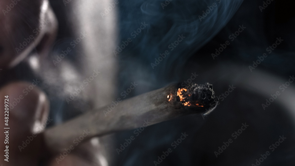 Fingers holding marijuana joint. Cannabis cigarette smoking. Stock ...