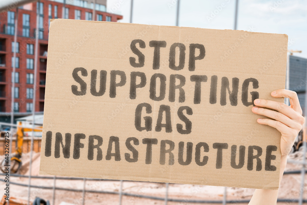 The phrase " Stop Supporting Gas Infrastructure " on a banner in men's ...