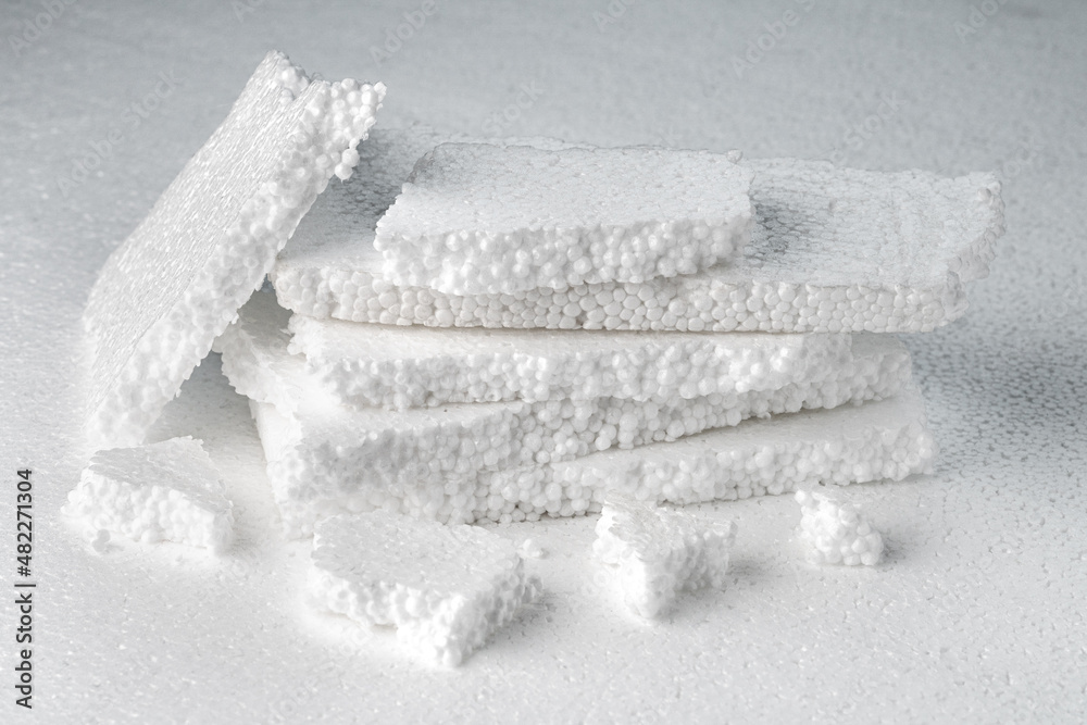 Stack of broken pieces of white styrofoam on the sheet of white ...