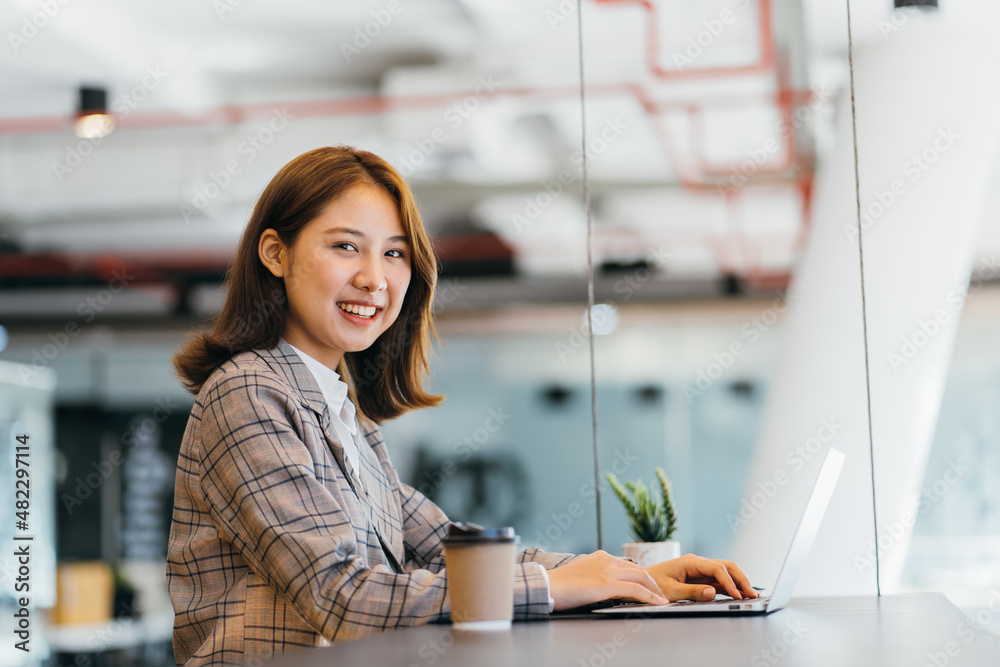 Asian woman working on a laptop computer,Working in the office with ...