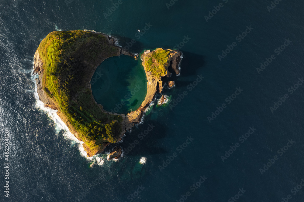 Round shaped island in sea Stock Photo | Adobe Stock