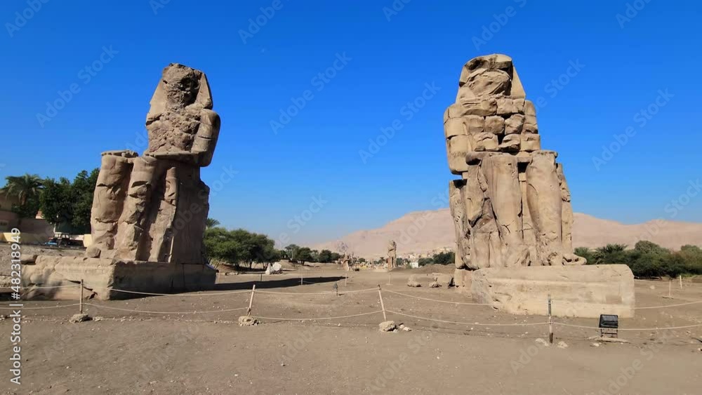 The Colossi of Memnon, two stone massive statues of the Pharaoh ...