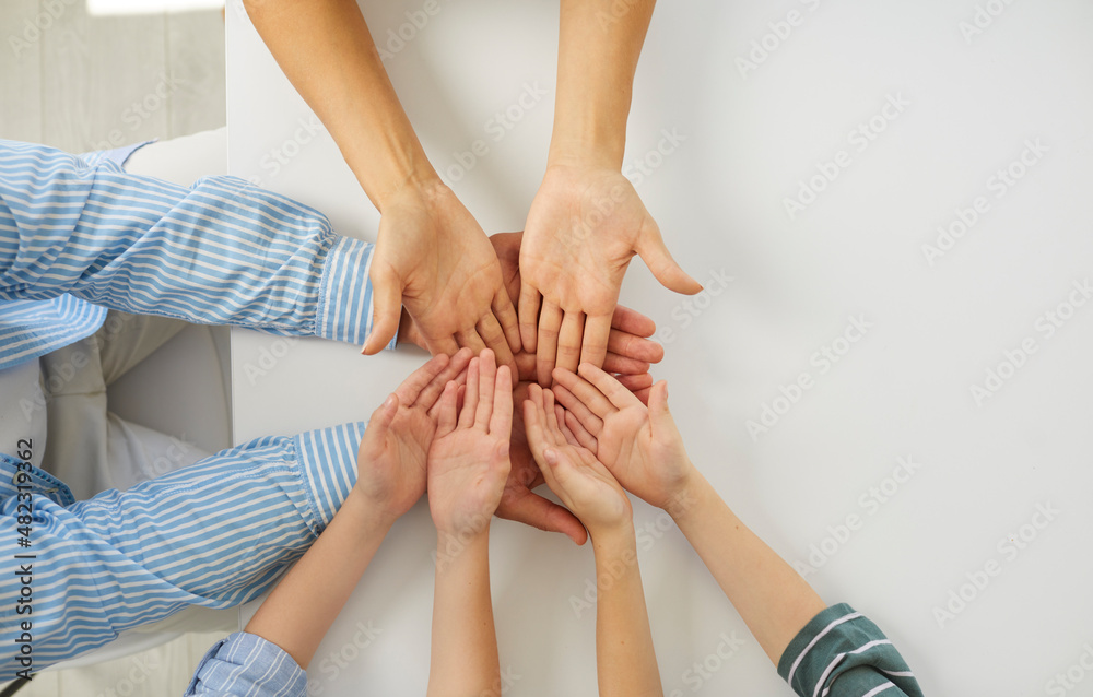 Family members holding each other's hands. Young mother and father ...