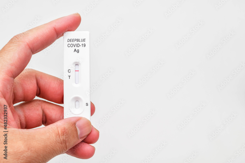 Hand holding Covid-19 negative test result with SARS-CoV-2 Rapid ...