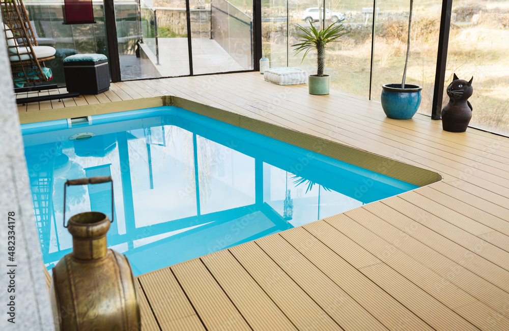 Blue swimming pool in modern home Stock Photo | Adobe Stock