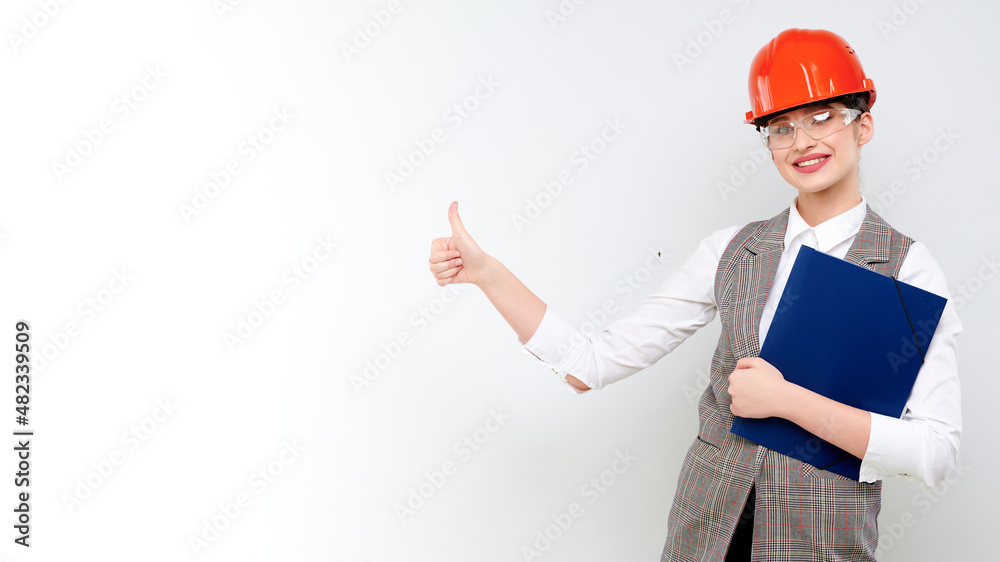 Young female caucasian engineer wearing orange constraction helmet and ...