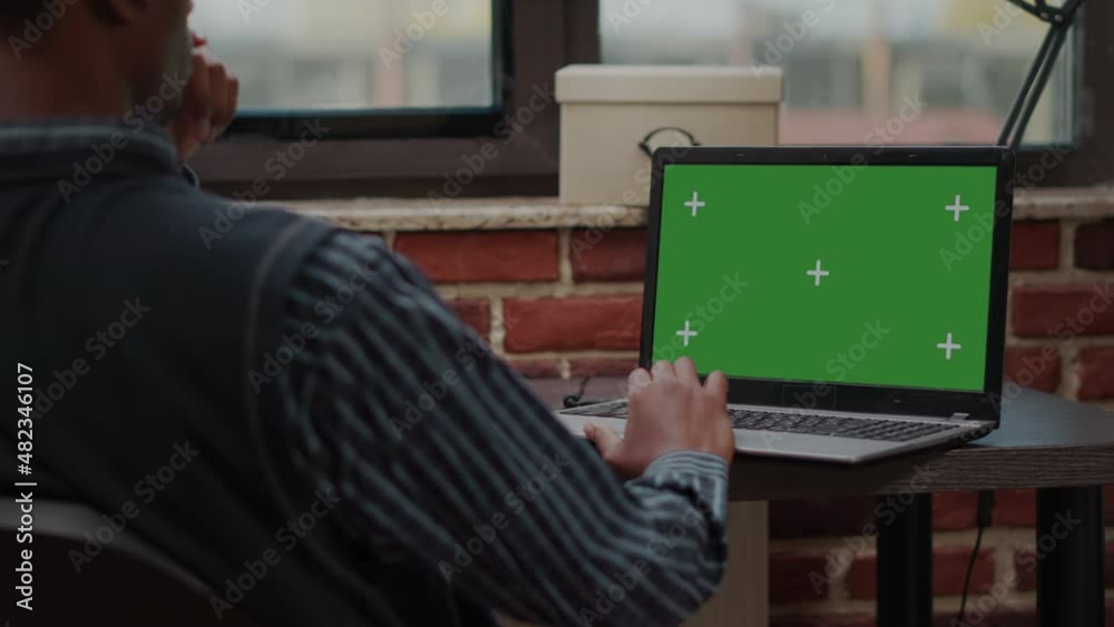 Company worker using laptop with green screen in business office ...