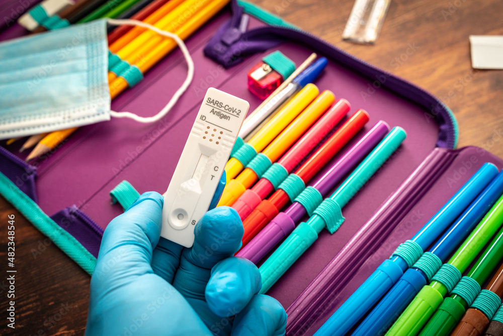 Corona antigen rapid test Covid 19 test on a table with crayons at ...