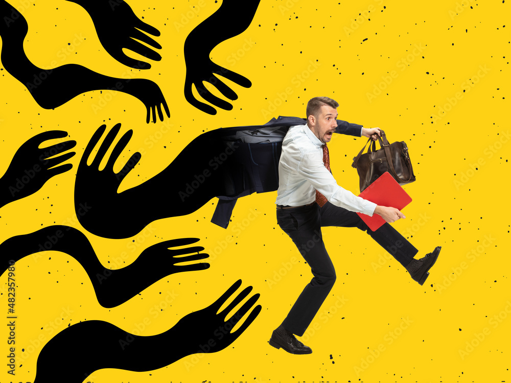 Scared young man, business man running away from giant drawn black ...