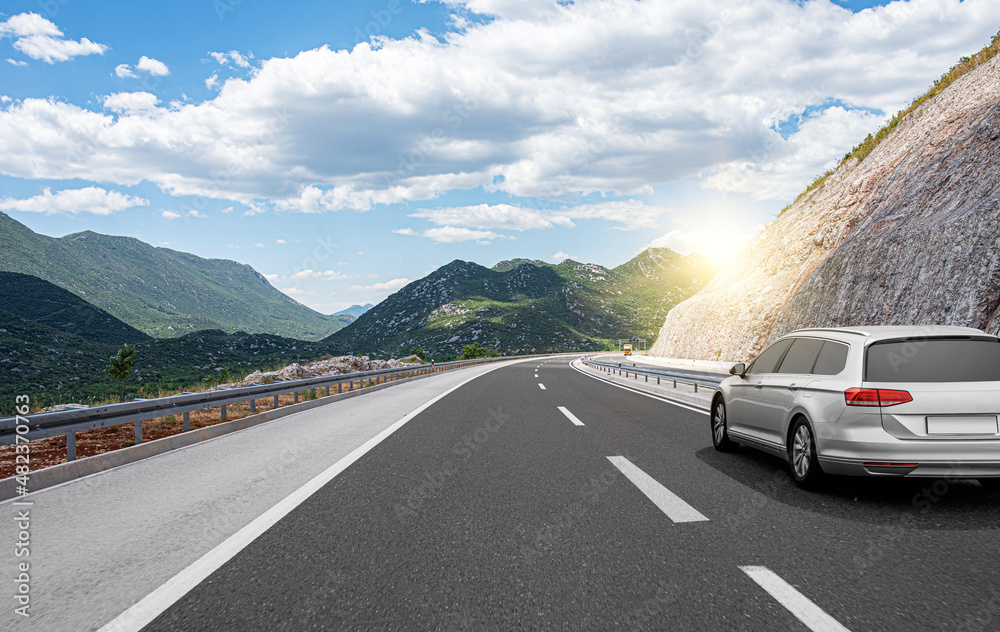 Car on a scenic road. Car on the road surrounded by a magnificent ...
