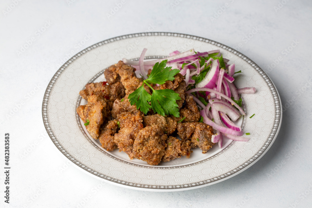 Fried liver cubes with onion and parsley. Liver pan (Albanian liver ...