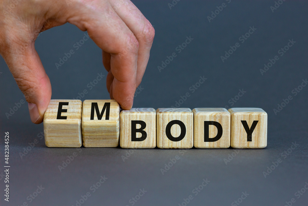 Body and embody symbol. Doctor turns wooden cubes and changes the ...
