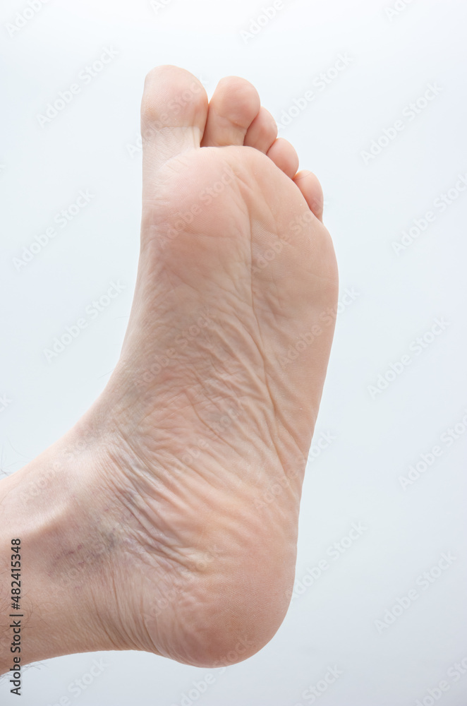 Caucasian male bare feet. Close up shot, isolated on white background ...