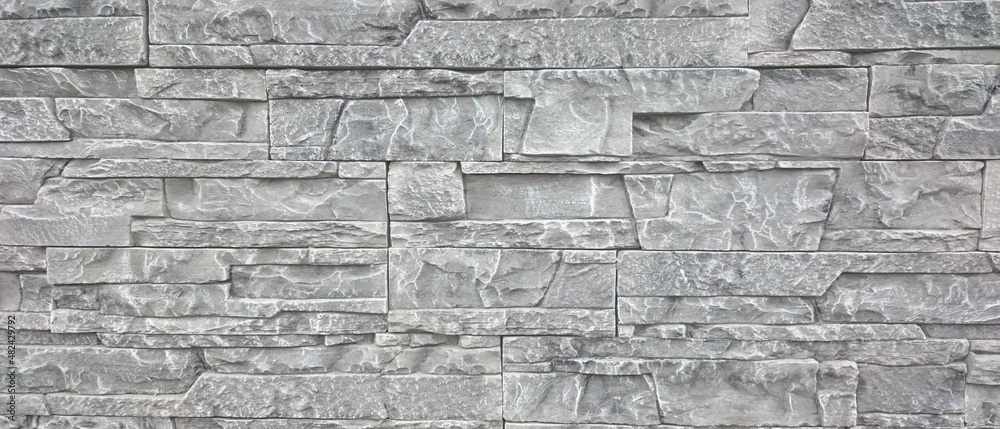 Elegant stone cladding wall made of gray granite with different shades ...