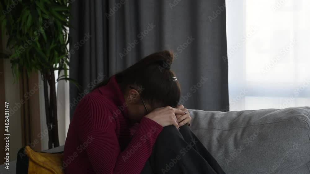 Young sad woman with broken heart sitting alone at home suffering from ...