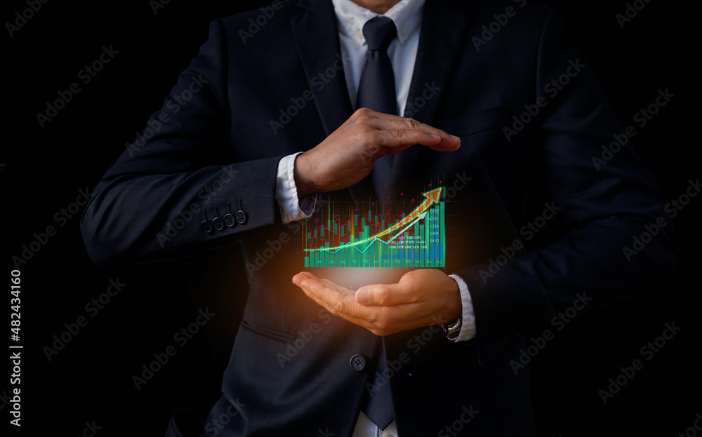 Businessman Hand analyzing sales data and economic growth graph chart ...