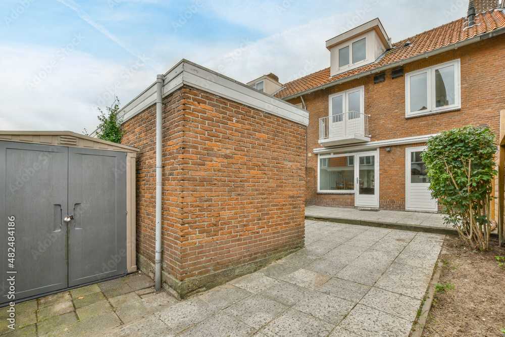 Exterior of a two-story house with red brick walls and its garage Stock ...