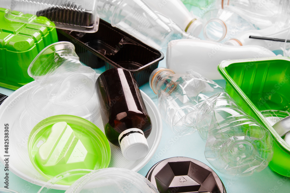 Separate collection of plastic garbage. PET stuff for recycle on blue ...