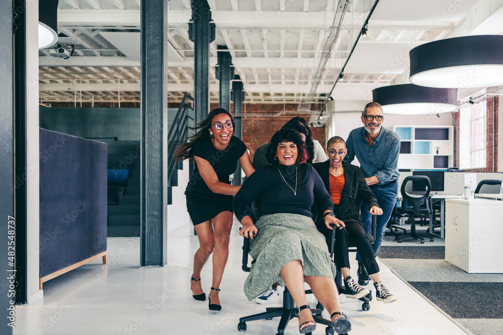 Diverse business people having fun together in the office. Team of ...