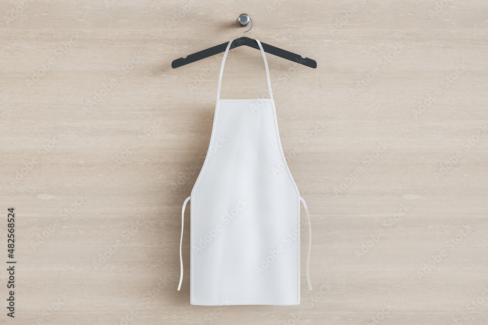 Empty white kitchen apron on hangers. Light wood background. Chef and ...