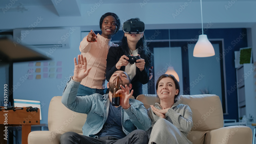 Diverse group of people playing video games with vr glasses and ...