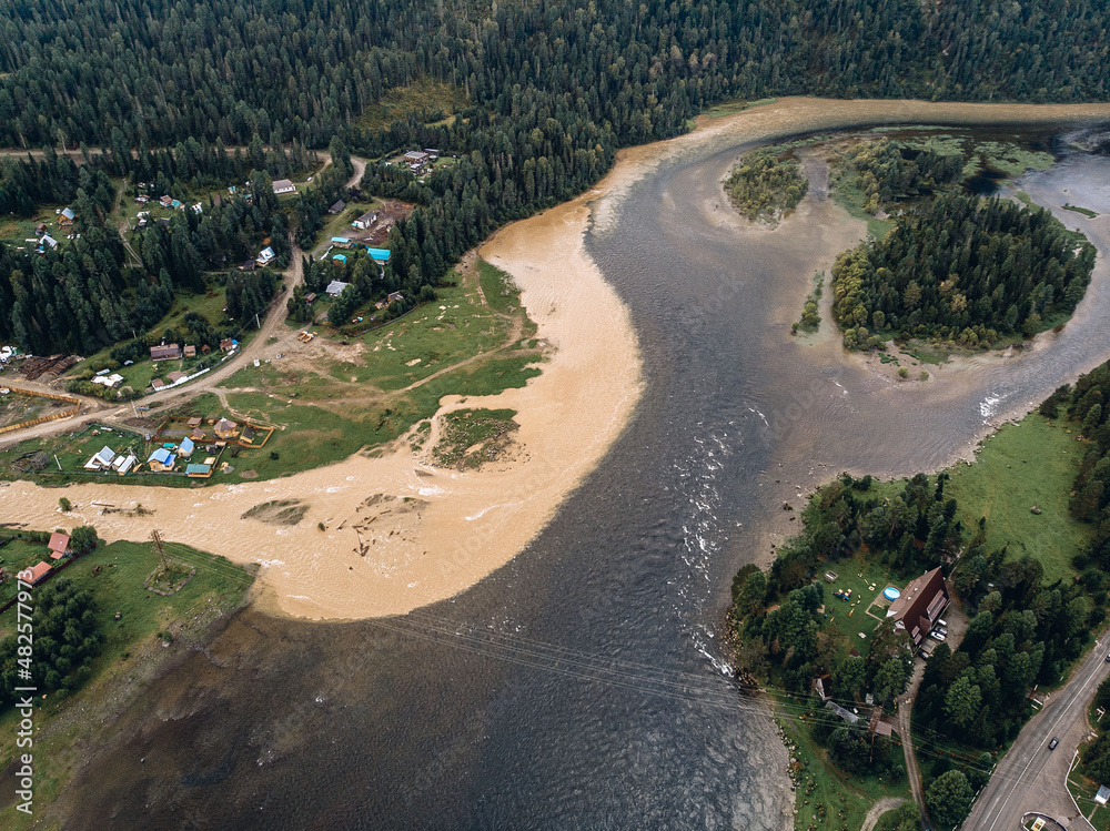 Top view of the oases. A huge lake with clear water around the sand ...