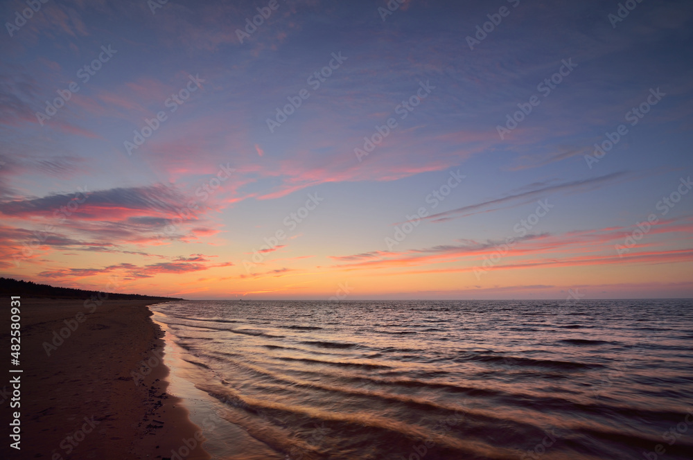 Baltic sea after the rain. Dramatic sunset sky, glowing pink and golden ...