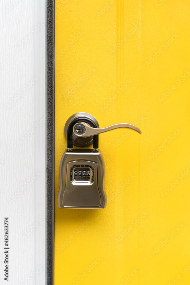 Photograph of a Real Estate Combination Lock Box placed on the handle ...