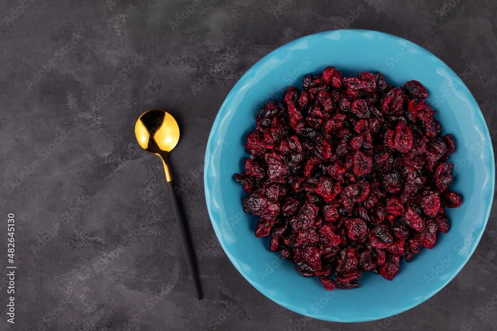 Dried cranberries in blue bowl top view. Healthy tasty dry red berries ...
