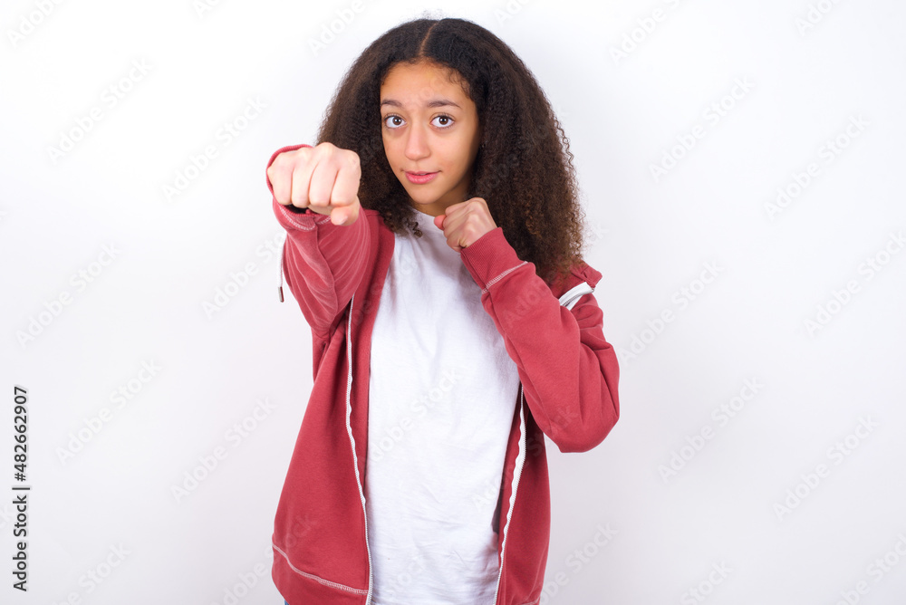 teenager girl wearing pink jacket standing against wite background ...